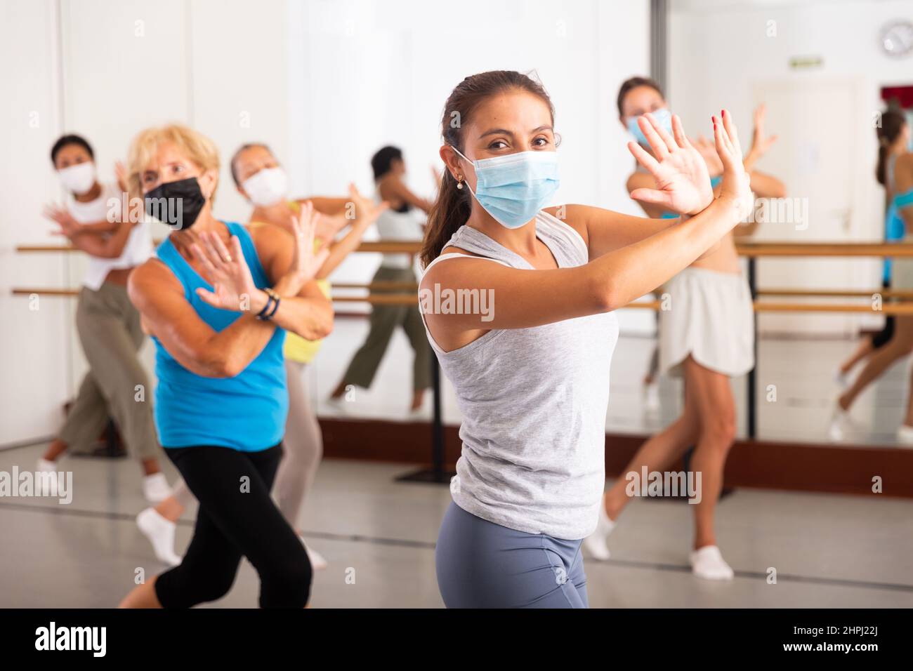 Women in masks dancing together in studio Stock Photo - Alamy