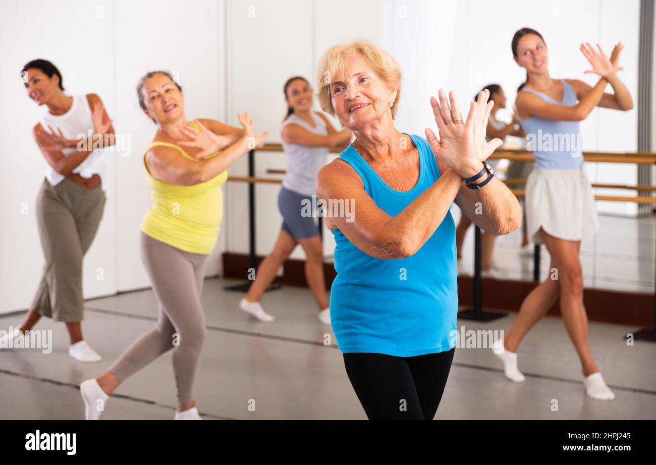Group of active women practicing energetic dance in a studio Stock ...