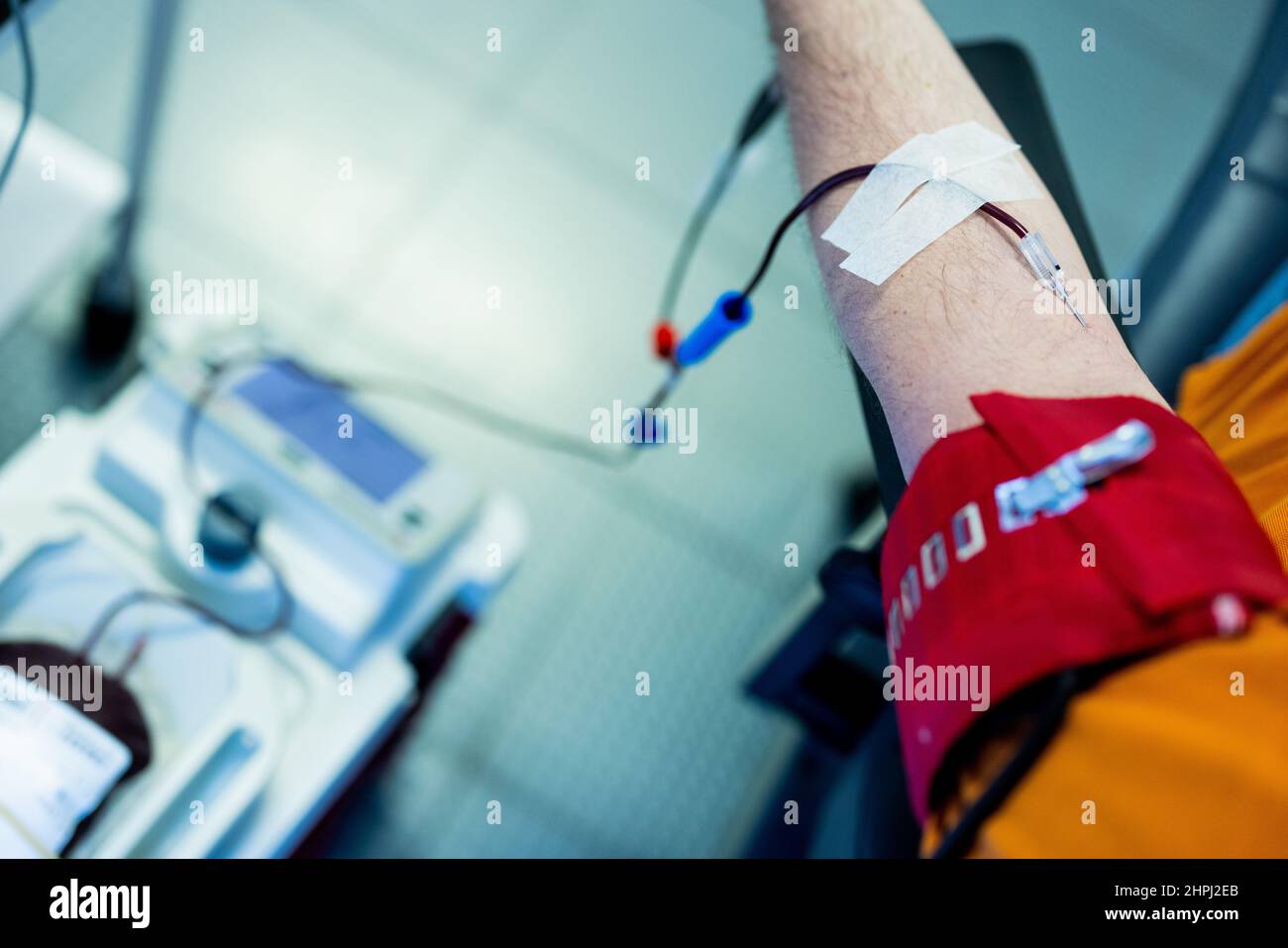 Essen, Germany. 15th Feb, 2022. A man donates blood at the DRK blood ...