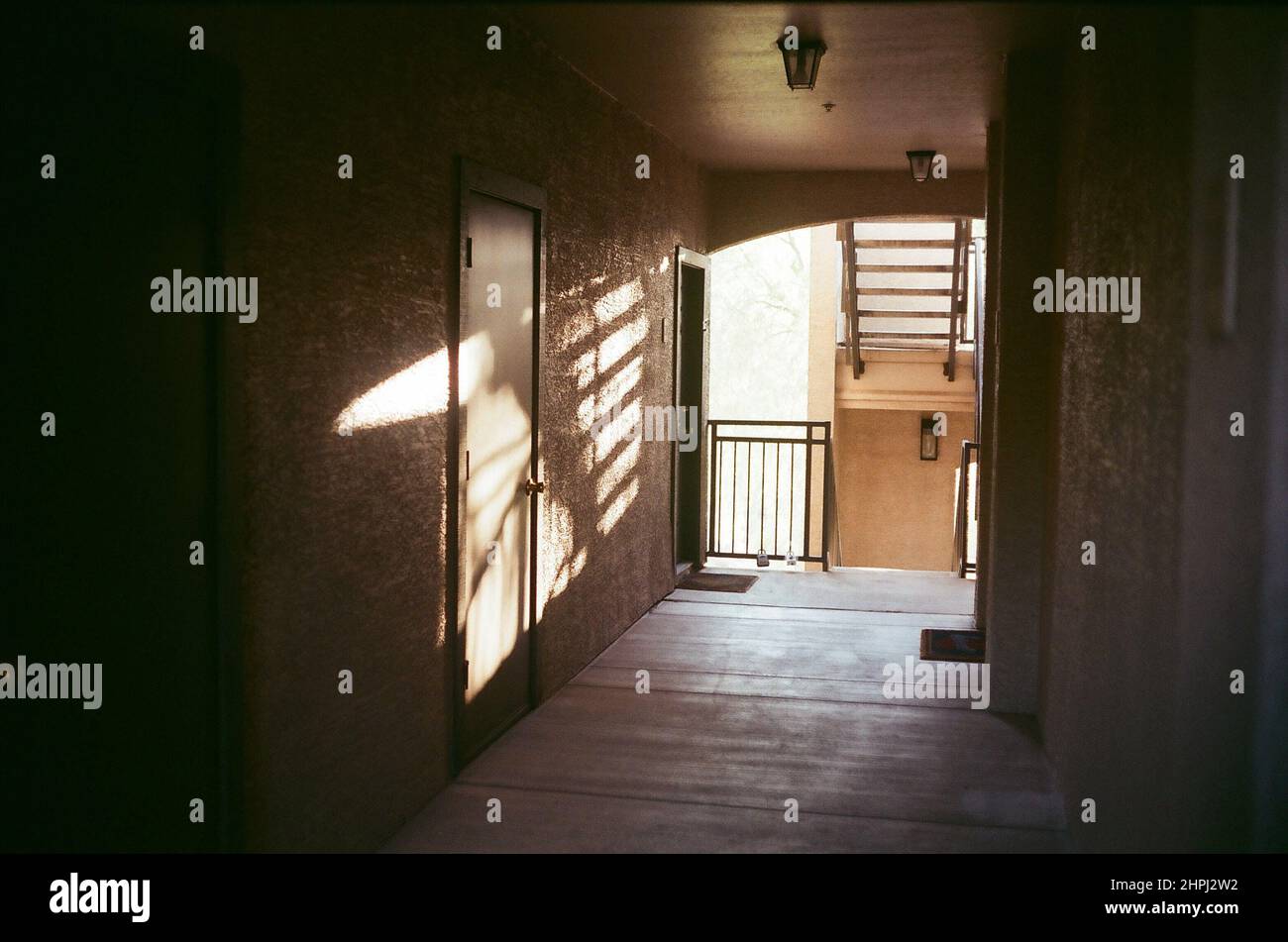 View of a corridor with an entrance with sunlight Stock Photo - Alamy