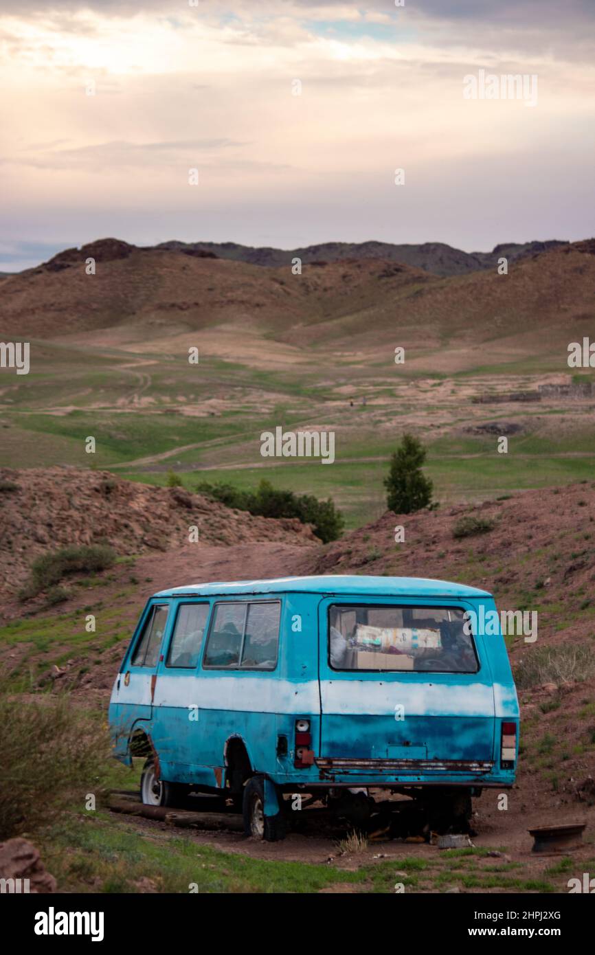 Beautiful view of a blue old van in the large forest with plants and ...