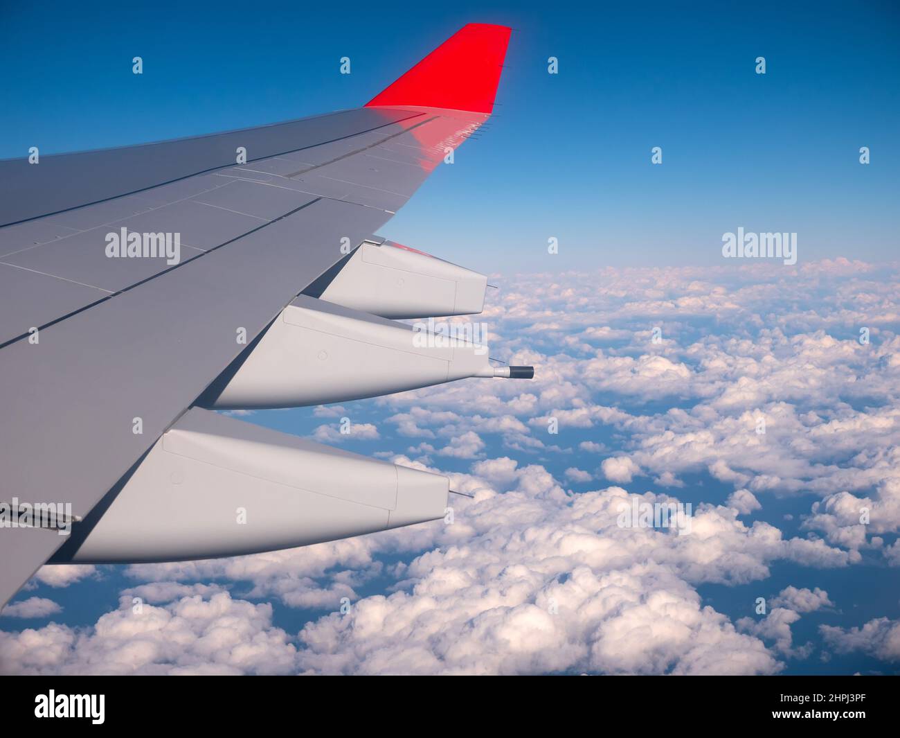 View from passenger window of flying airplane wing Stock Photo - Alamy