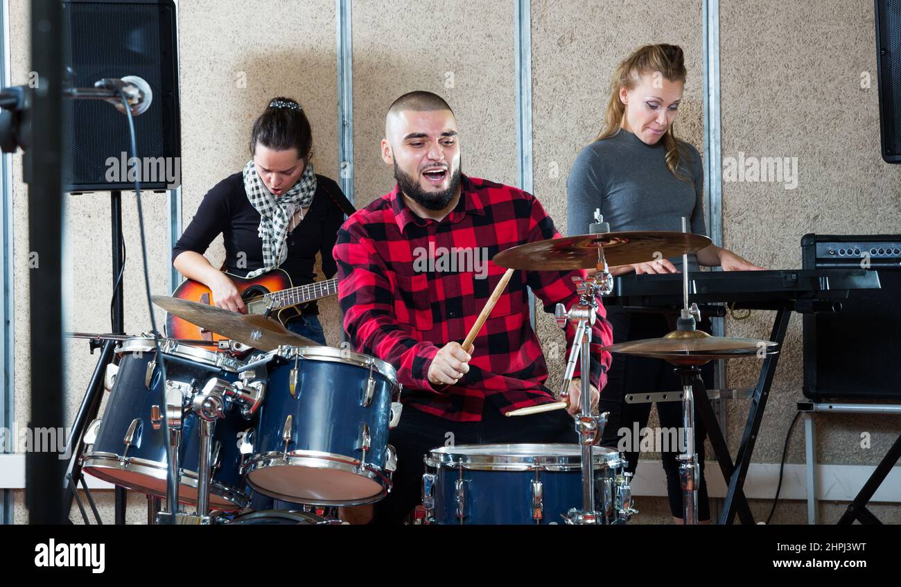 Garage band rehearsing in studio Stock Photo - Alamy