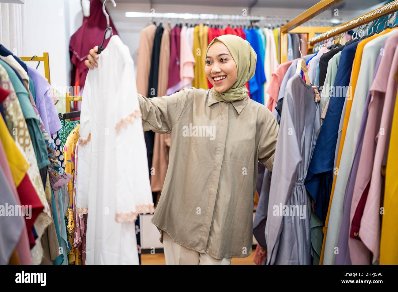 muslim female confuse of choosing between two clothes Stock Photo - Alamy
