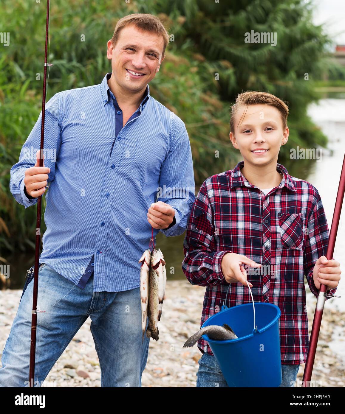 Family with catched fish Stock Photo - Alamy
