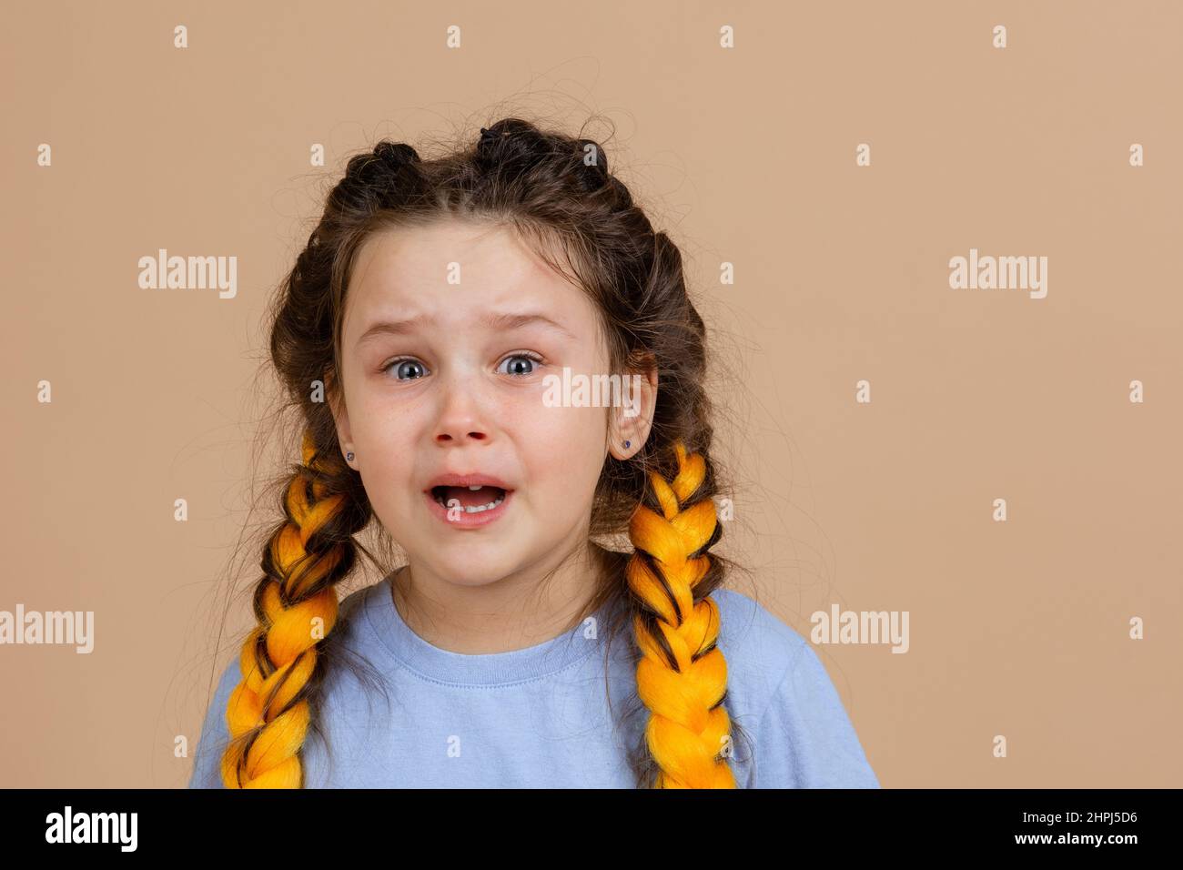 Sad small female with tears in eyes crying with open mouth with missing ...