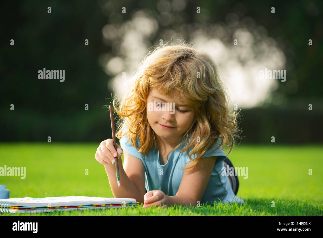 Children draw paint pictures outside, childrens creativity. Portrait of ...
