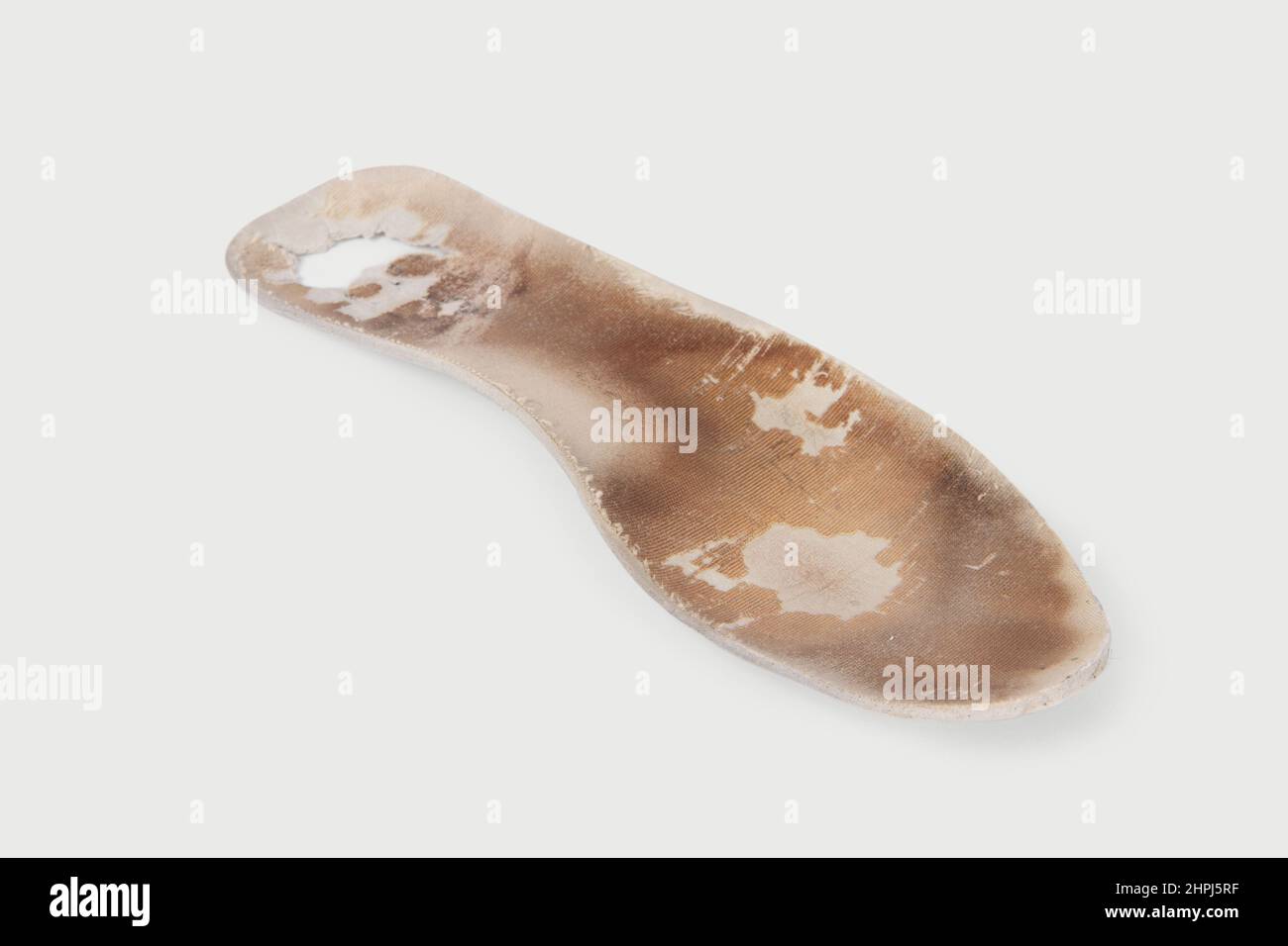 Old and shabby orthopedic insoles isolated on white background. Dirty ...