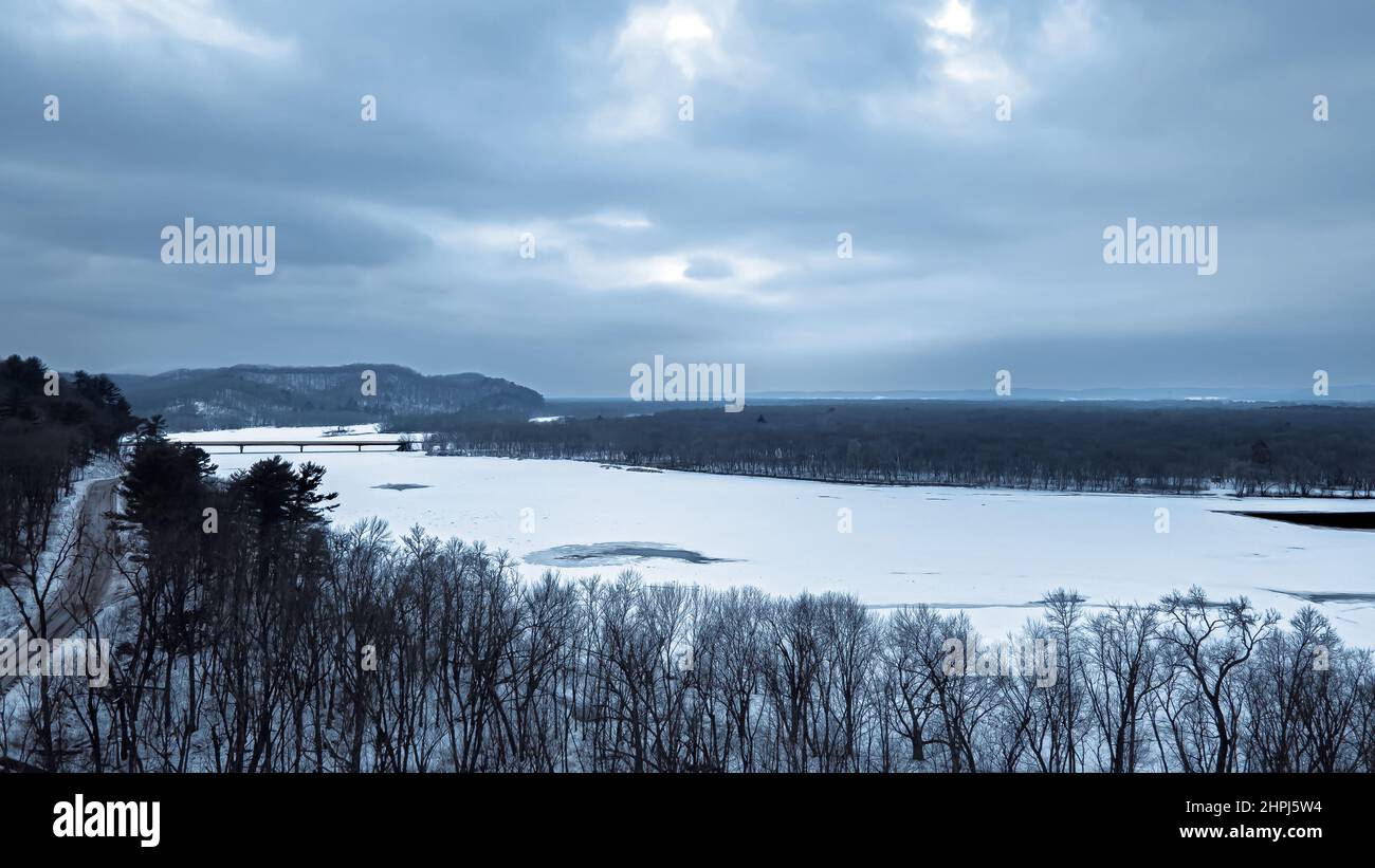 A cold view of the frozen river heading through the land Stock Photo ...