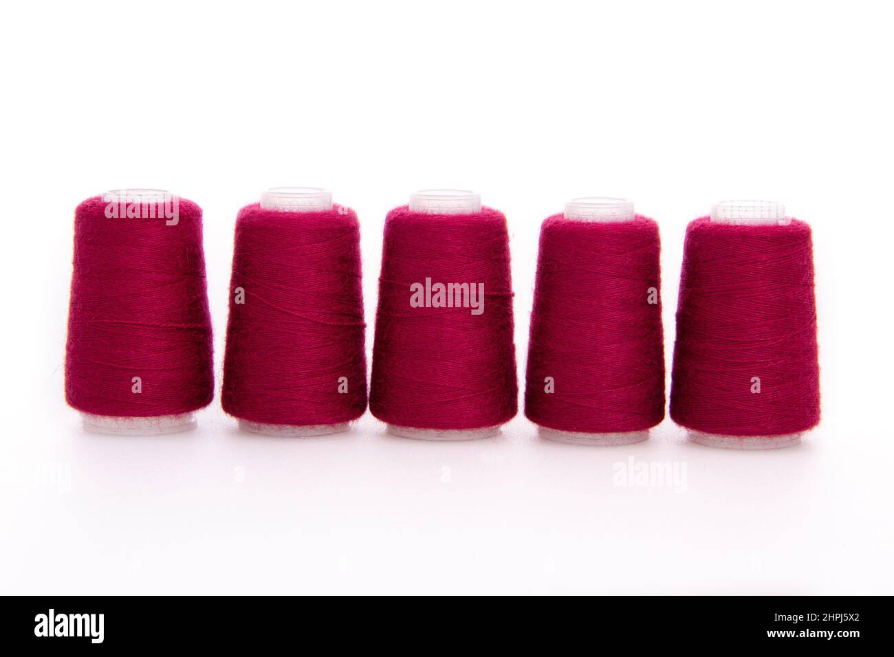 Red spool of thread isolated on white background. Skein of woolen ...