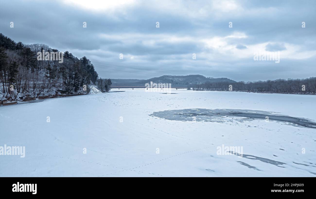 A cold view of the frozen river heading through the land Stock Photo ...