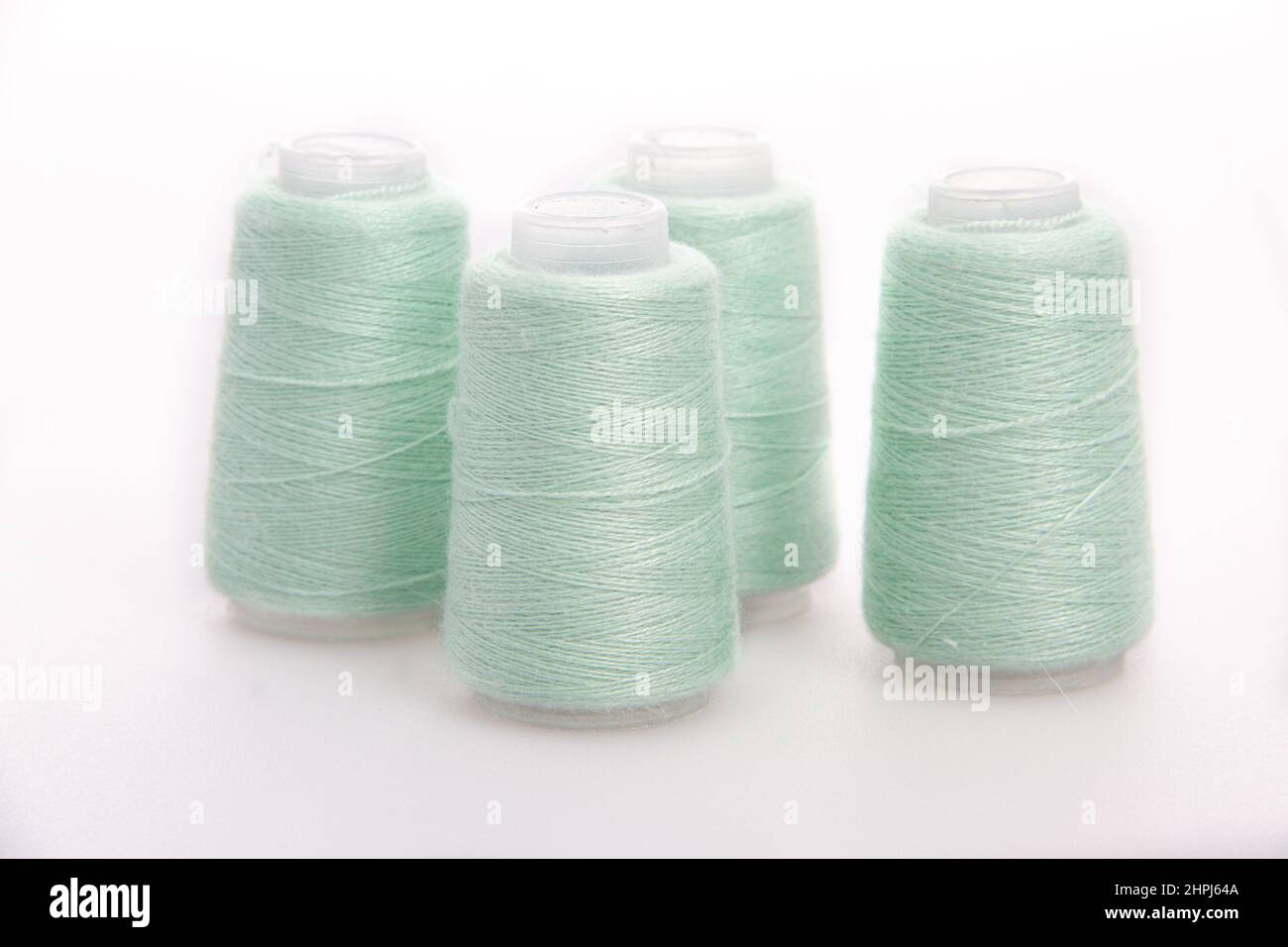 Green spool of thread isolated on white background. Skein of woolen ...