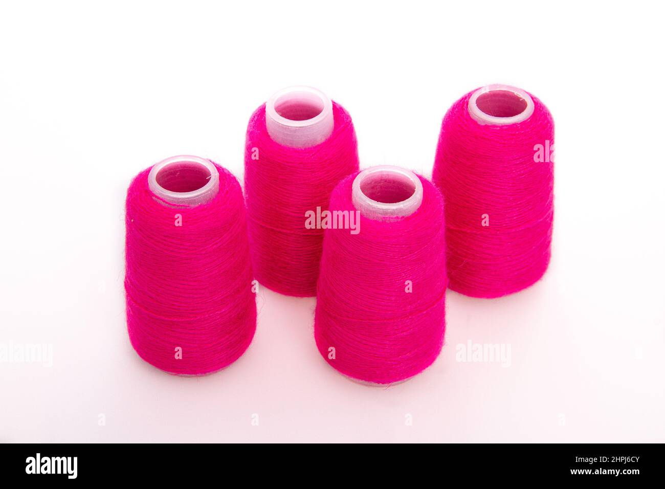 Pink spool of thread isolated on white background. Skein of woolen ...