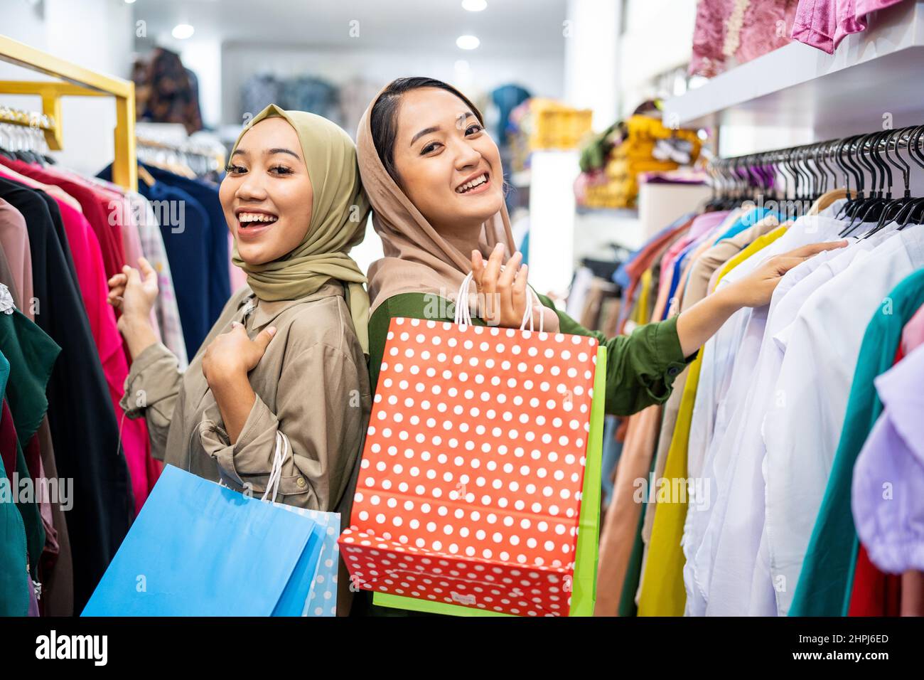 muslim female friend buying new dress at fashion store Stock Photo - Alamy