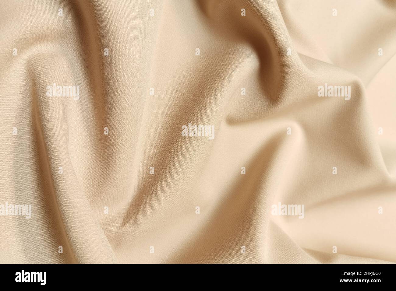 Golden crumpled or wavy fabric texture background. Abstract linen cloth soft waves. Silk atlas ...