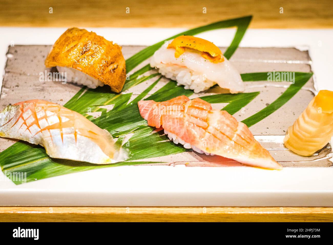 a variety of handmade nigiri sushi served on a porcelain slab Stock ...