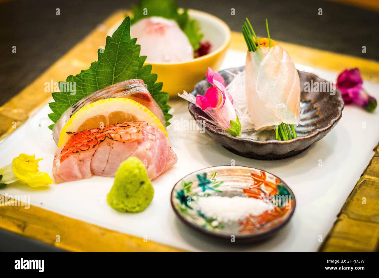 a raw fish sashimi set presented on a china plate in a Japanese ...