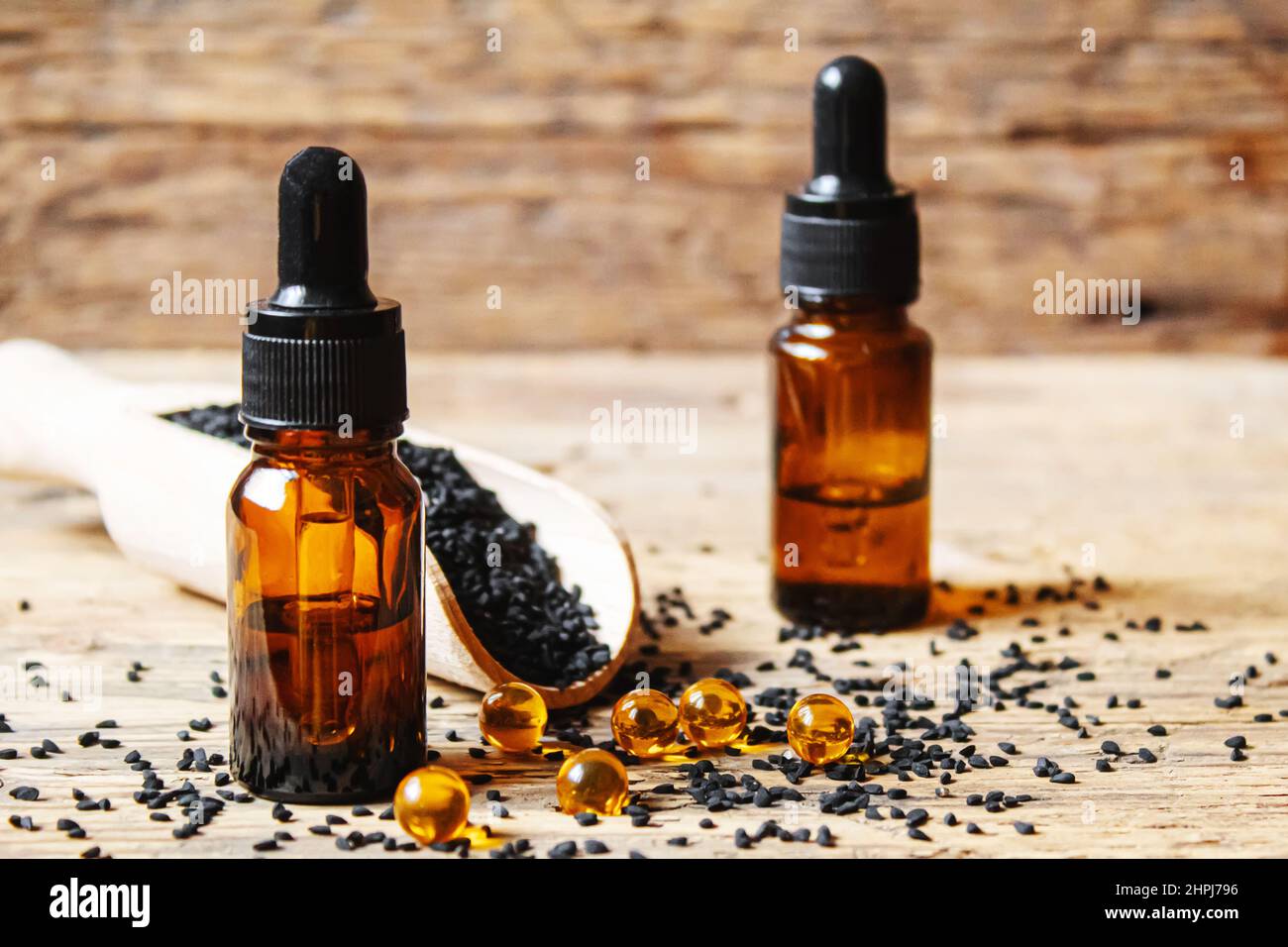 Black cumin essential oil in a small bottle. Selective focus. nature ...