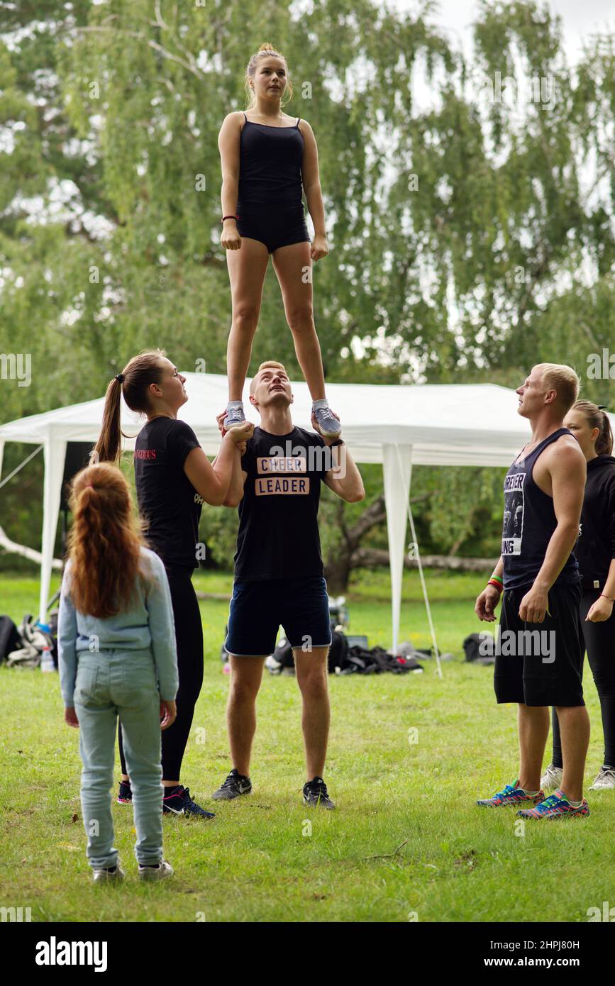 Group of excited young cheerleaders cheering on field Stock Photo - Alamy