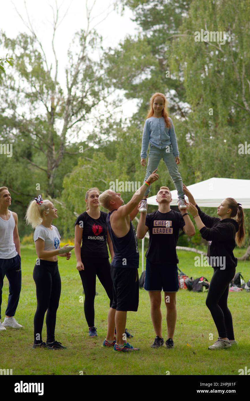 Group of excited young cheerleaders cheering on field Stock Photo - Alamy