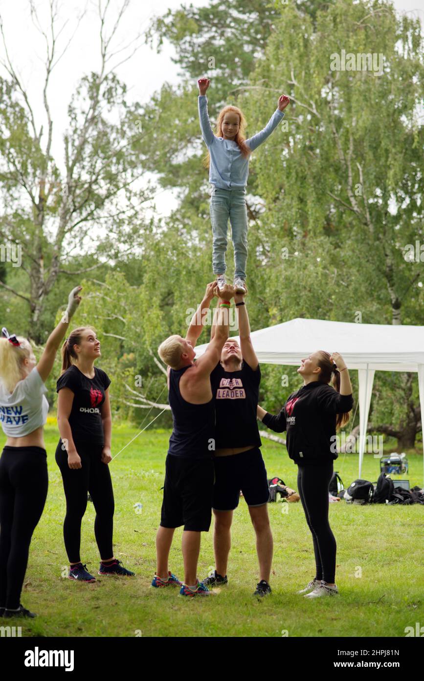 Group of excited young cheerleaders cheering on field Stock Photo - Alamy