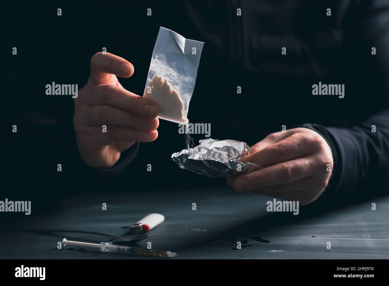Addict/junkie man preparing drugs. The concept of crime and drug ...