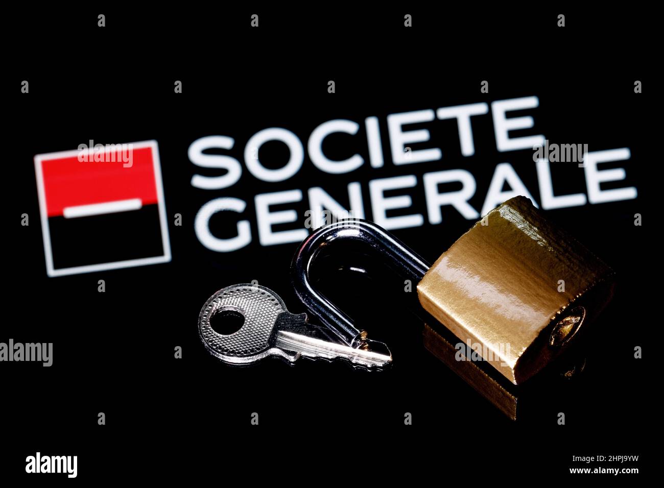 An open security lock and key on background of Societe Generale bank ...