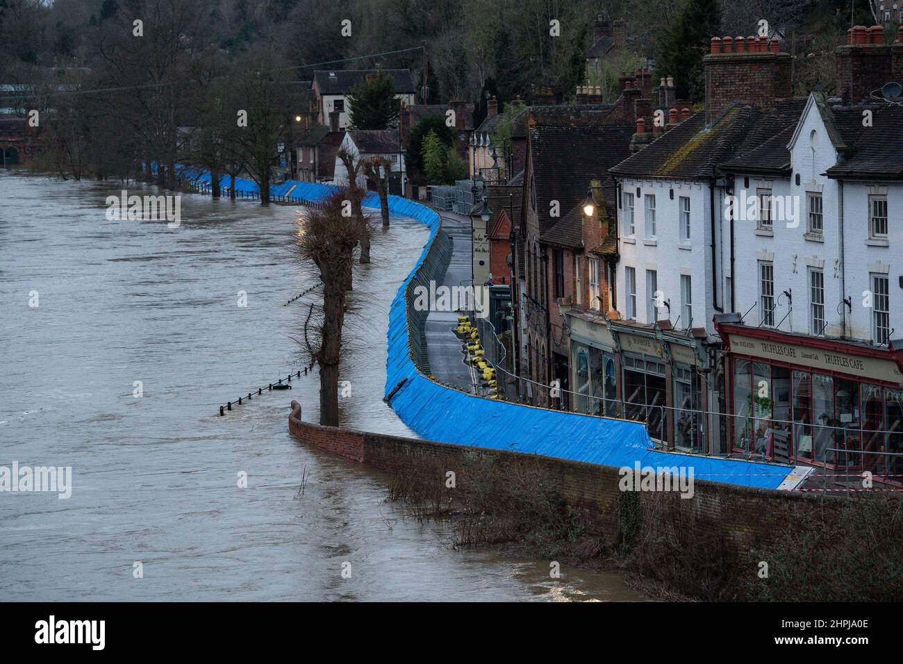 Flood defences hold back the River Severn despite it bursting its banks ...