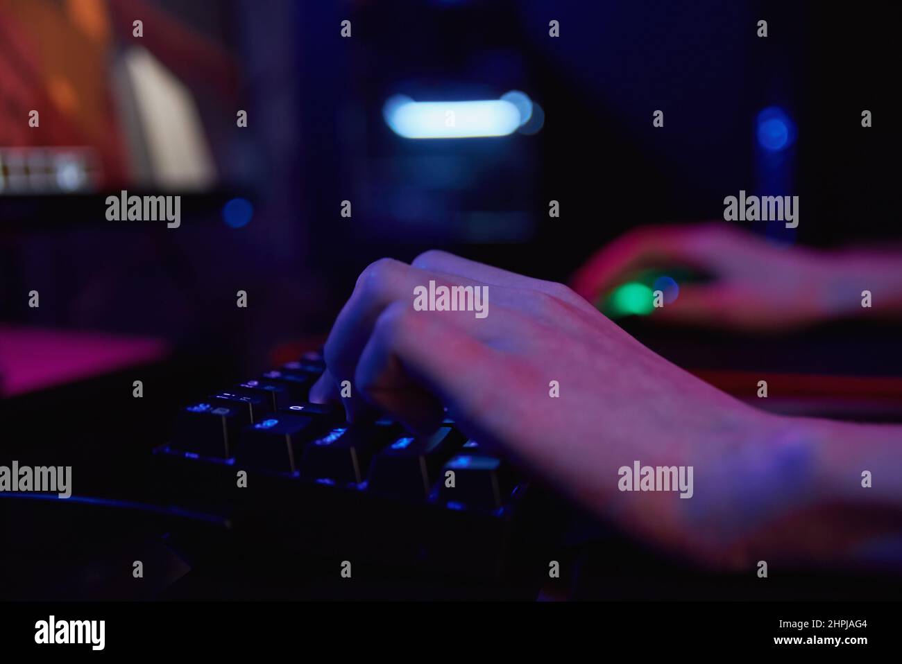 Professional gamer play computer video game in dark room, use neon ...