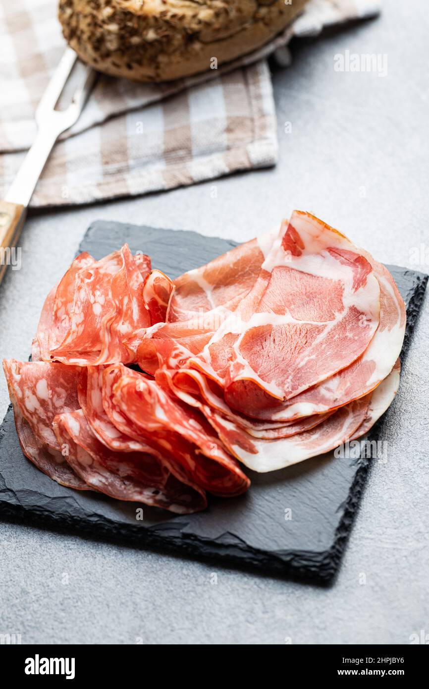 Italian dried ham. Coppa Stagionata, prosciutto and salami on a cutting ...