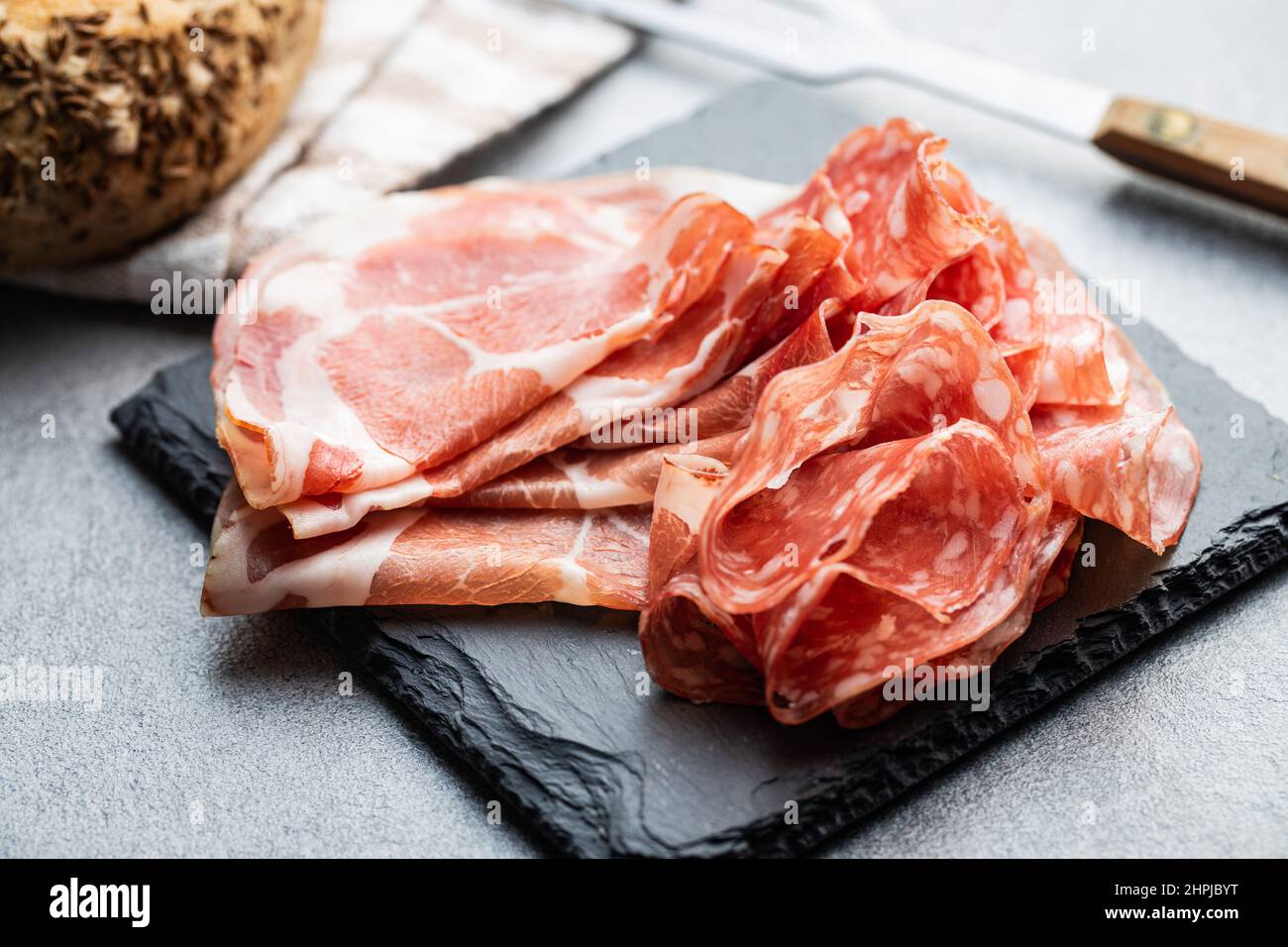Italian dried ham. Coppa Stagionata, prosciutto and salami on a cutting ...