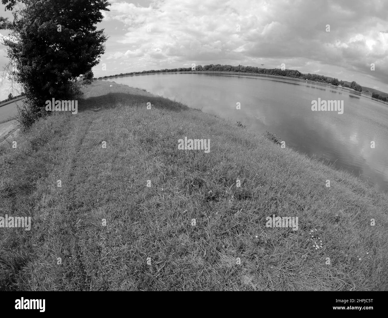 Grayscale of a landscape with river Stock Photo - Alamy