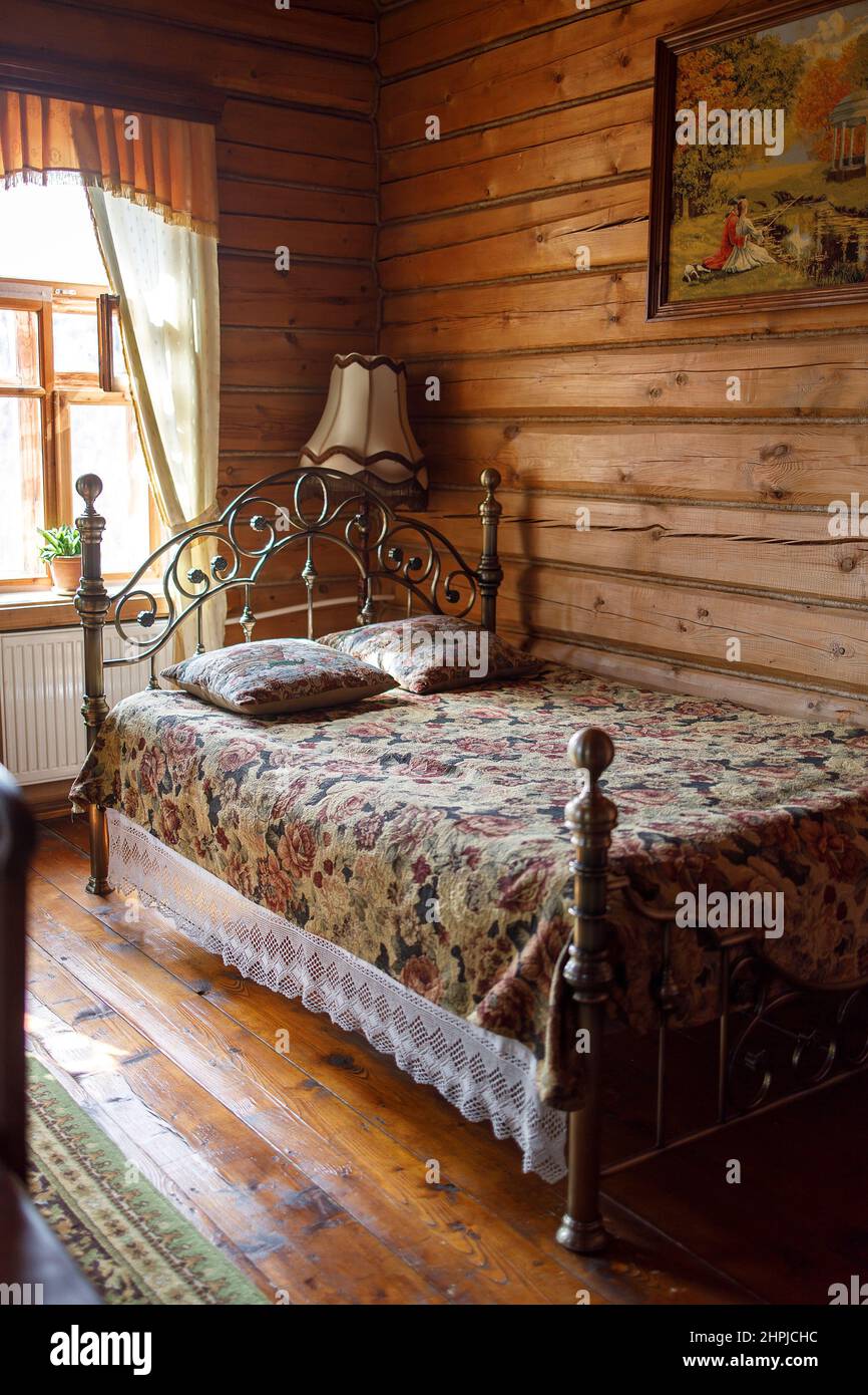 Bedroom interior in Russian merchant style. An iron bed with a wrought ...