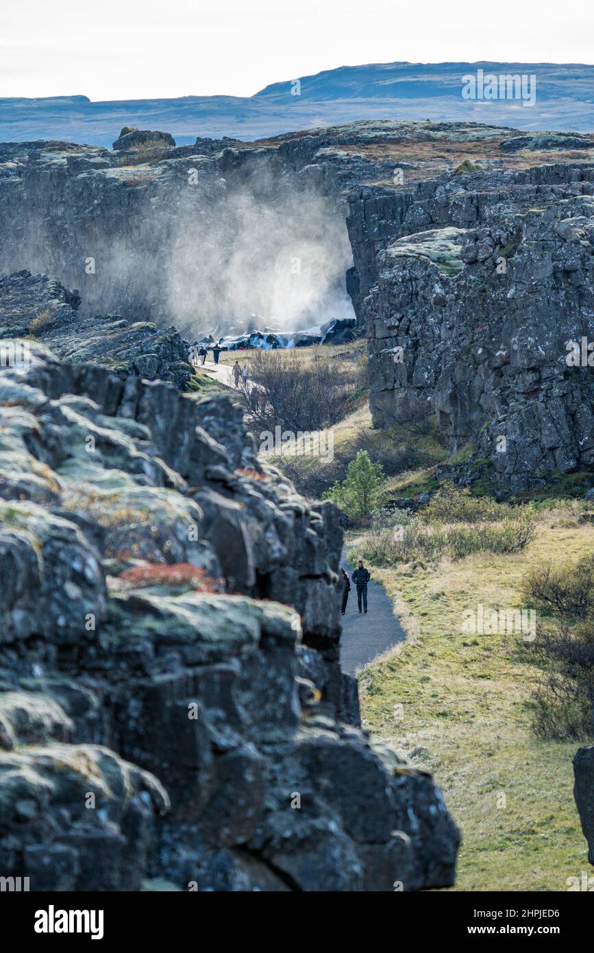 Thingvellir fault with tourists walking and waterfall Stock Photo - Alamy