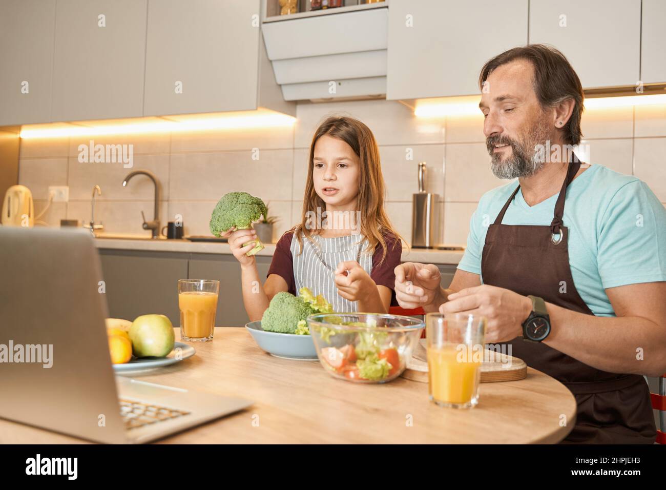 Teenage daughter with father in kitchen hi-res stock photography and ...