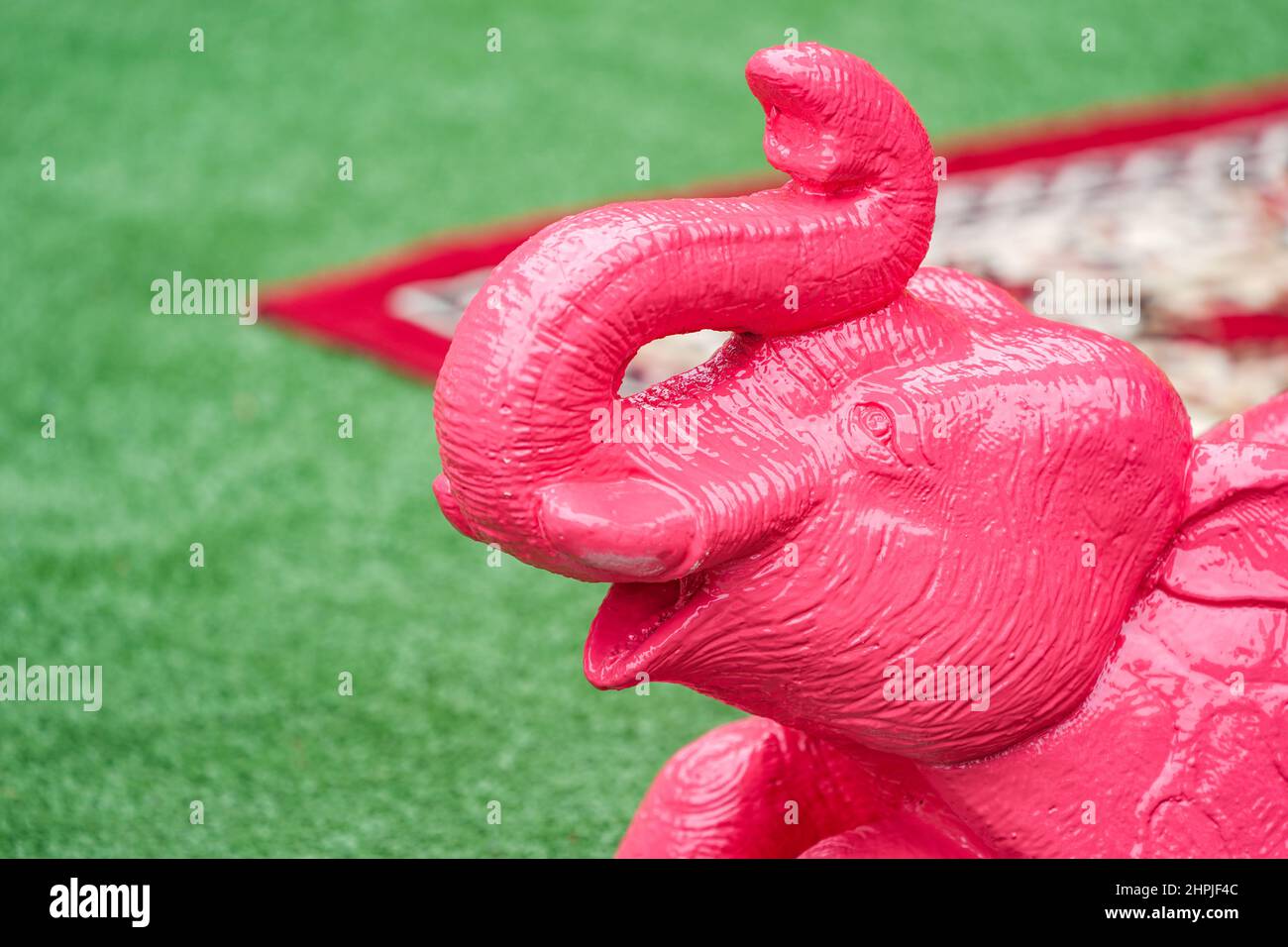 Asian Elephant statue figure sit and lay on the green turf Stock Photo ...