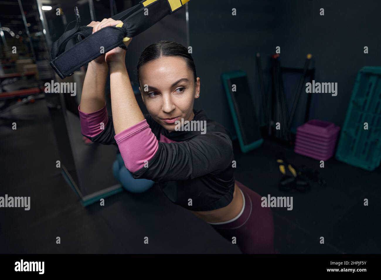 Thoughtful female person stretching her back during training Stock ...