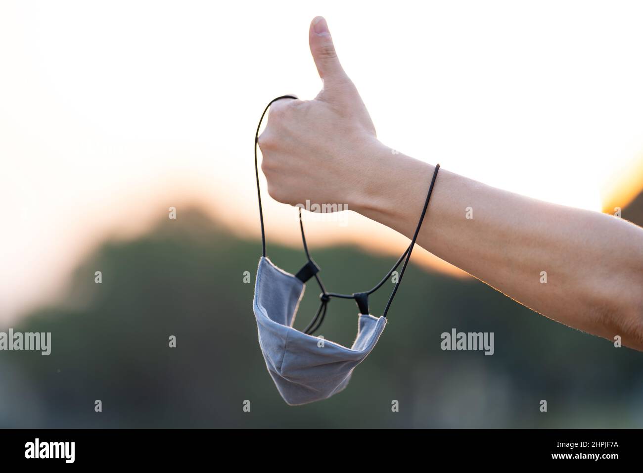 Close up to textile fabric mask is hanged on to man arm with the ...