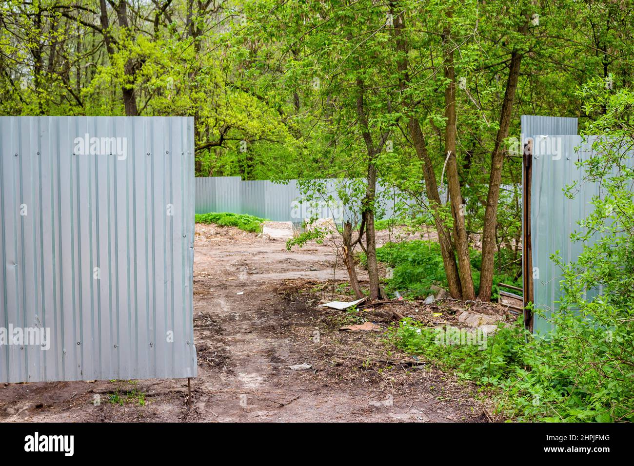 Corrugated fence with a gate around the construction site Stock Photo ...