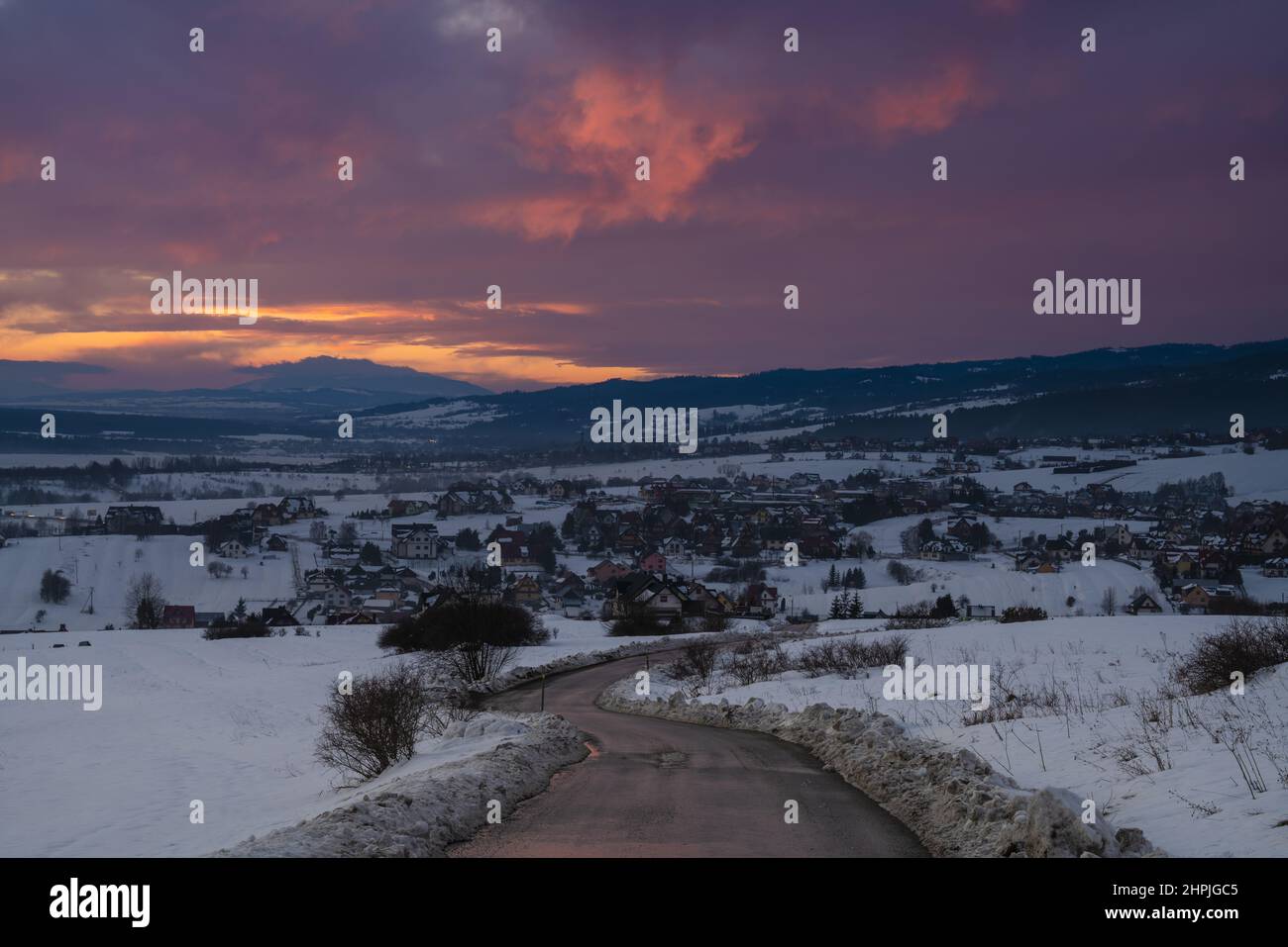 mountain road in snowy winter during a magnificent sunset Stock Photo ...