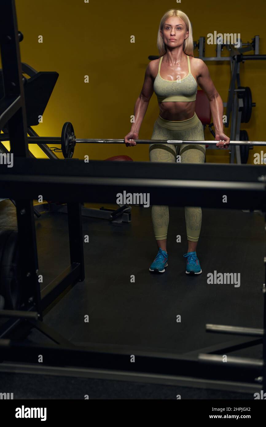 Kind female person lifting barbell in the gym Stock Photo - Alamy