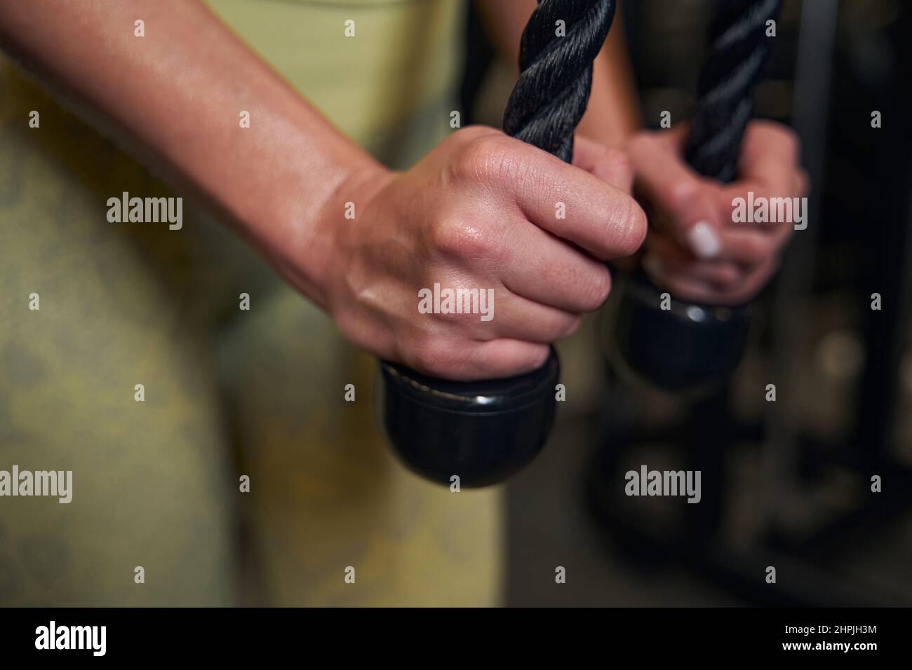 Focused photo on female hands holding rope Stock Photo - Alamy