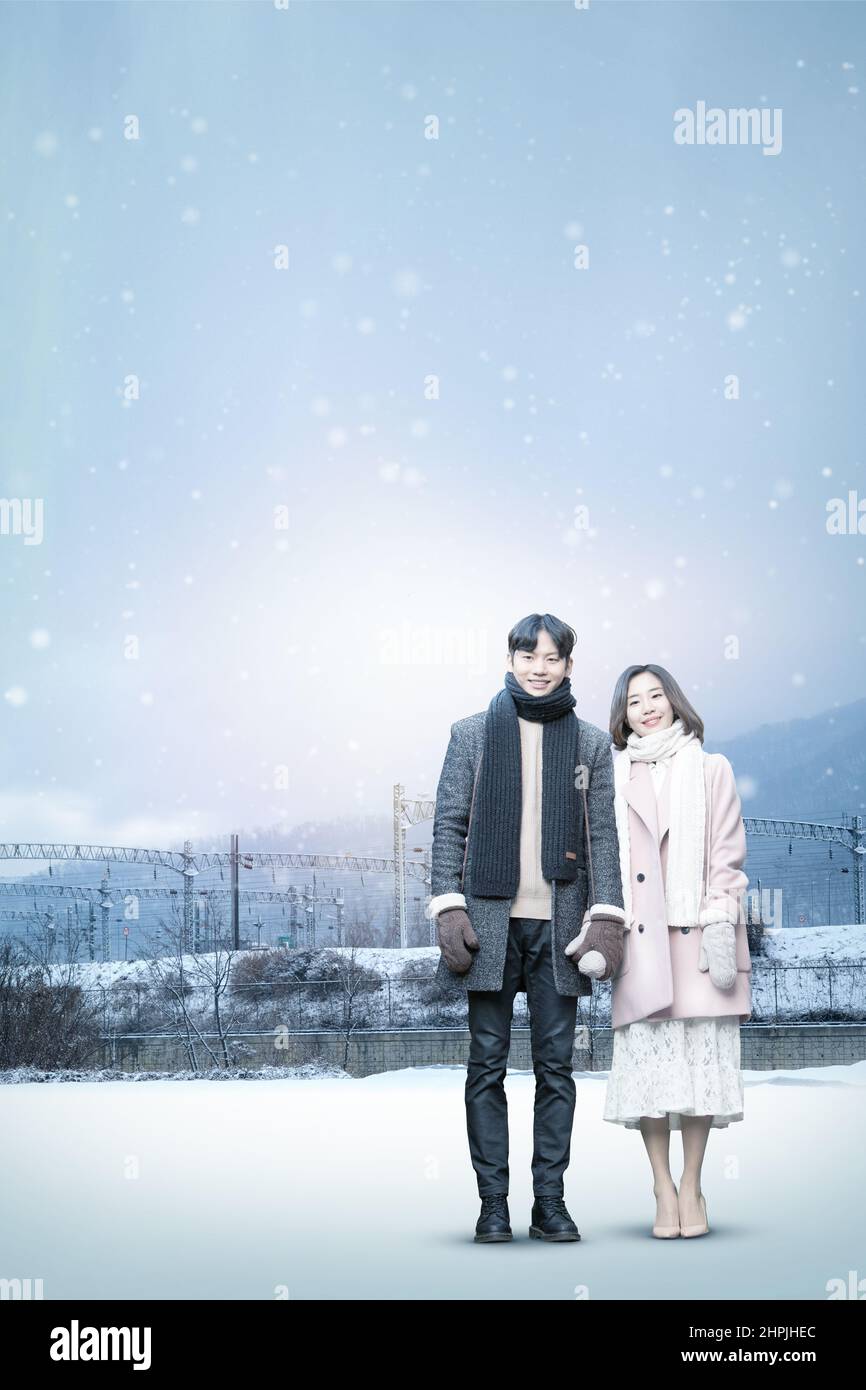 Asian Korean couple in snowing winter background Stock Photo - Alamy