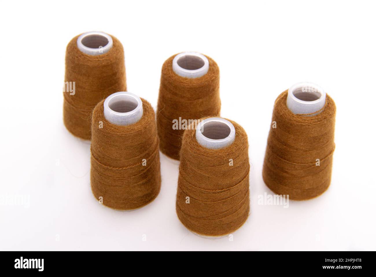 Brown spool of thread isolated on white background. Skein of woolen ...