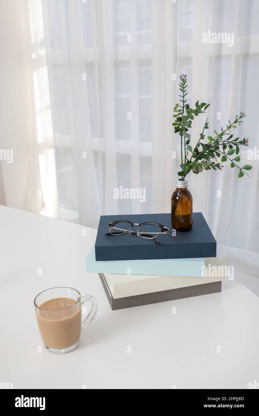relax cozy objects and background with milk tea, a book, glasses ...