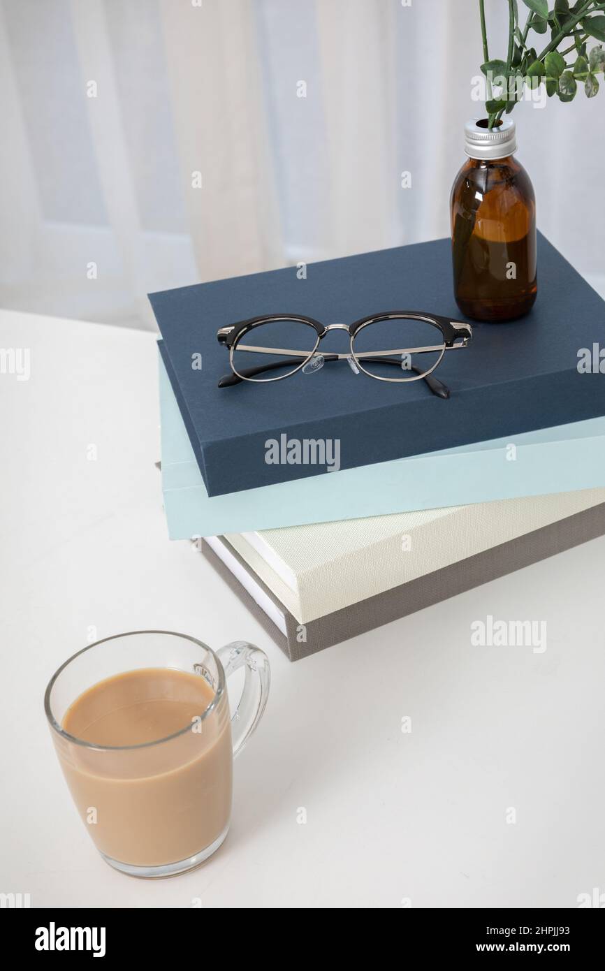 relax cozy objects and background with milk tea, a book, glasses ...