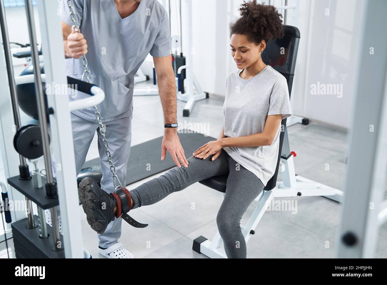 Young lady undergoing leg rehabilitation in the gym Stock Photo - Alamy