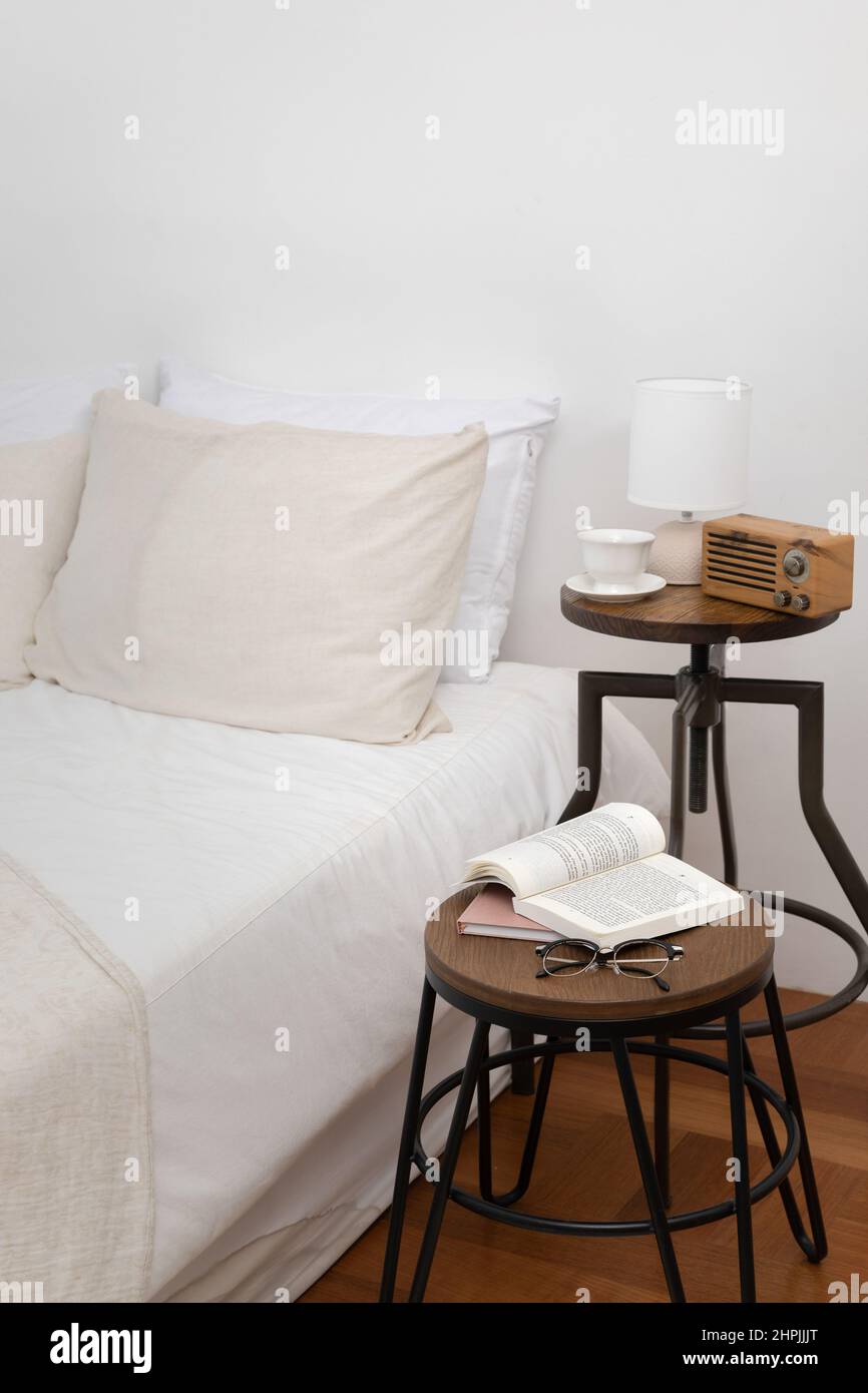 relax cozy objects and background with bedding, lights, coffee, a book ...