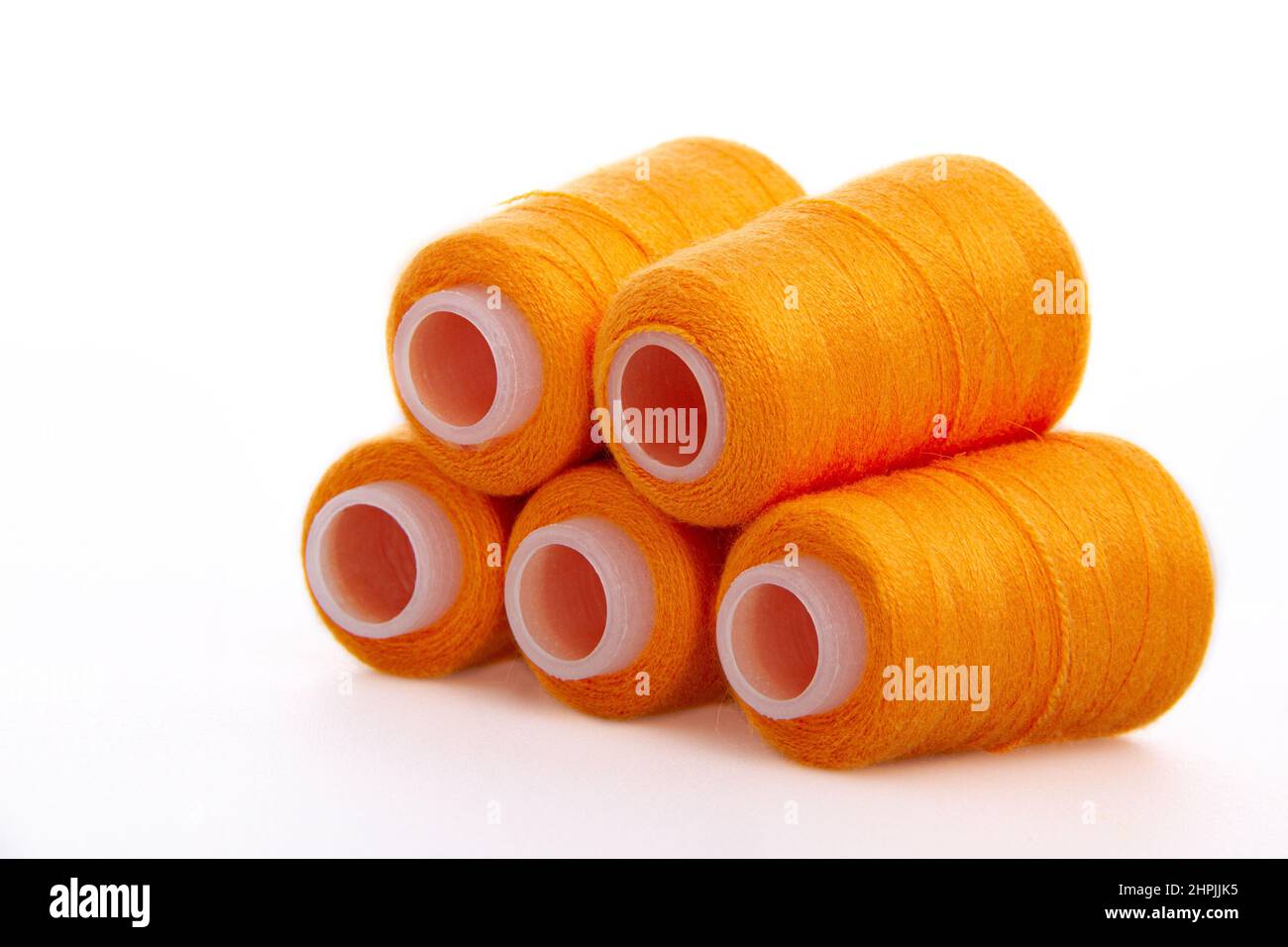 Orange spool of thread isolated on white background. Skein of woolen ...