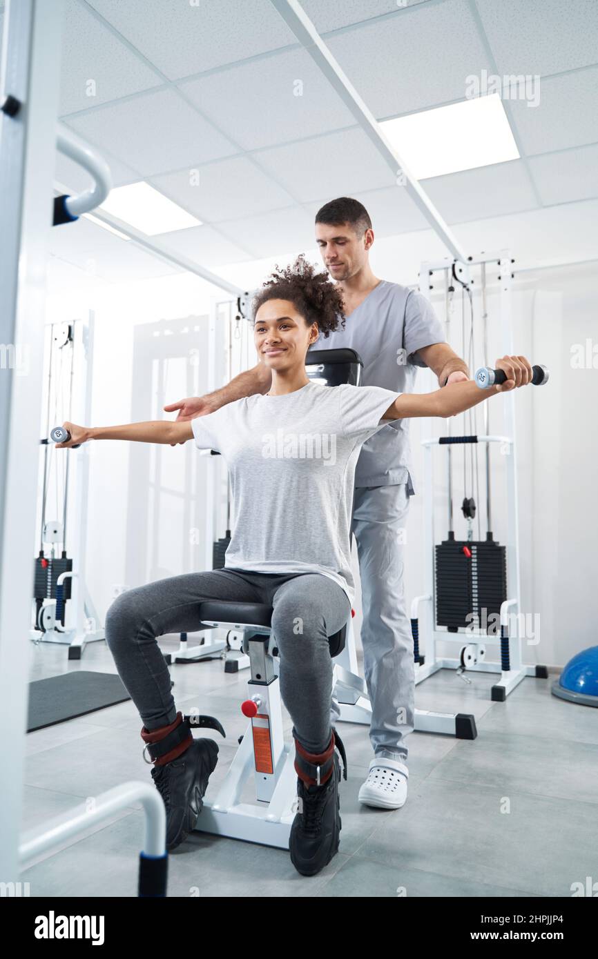 Female undergoing leg rehabilitation in the gym Stock Photo - Alamy